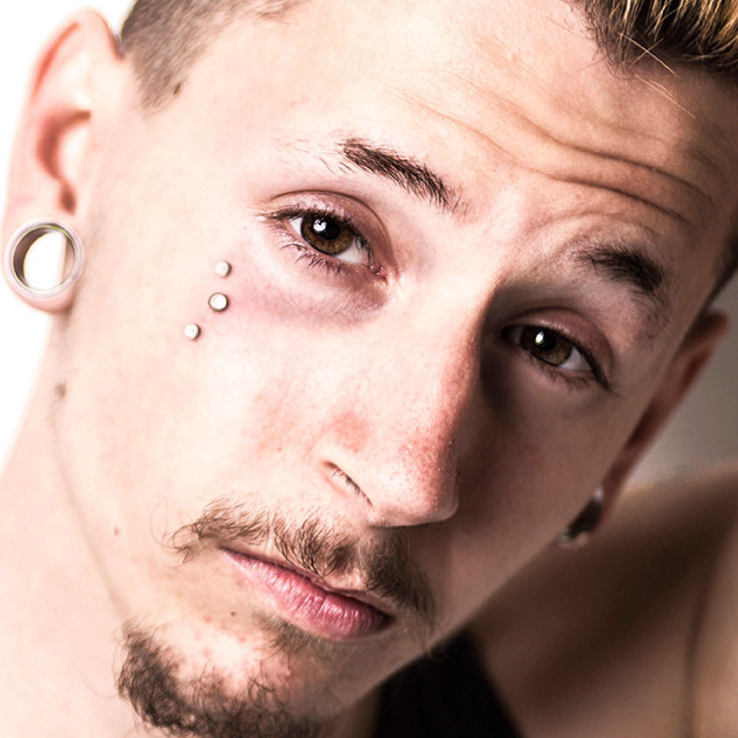 What To Know About Anti-Eyebrow Piercing: Aftercare, Scarring, & More